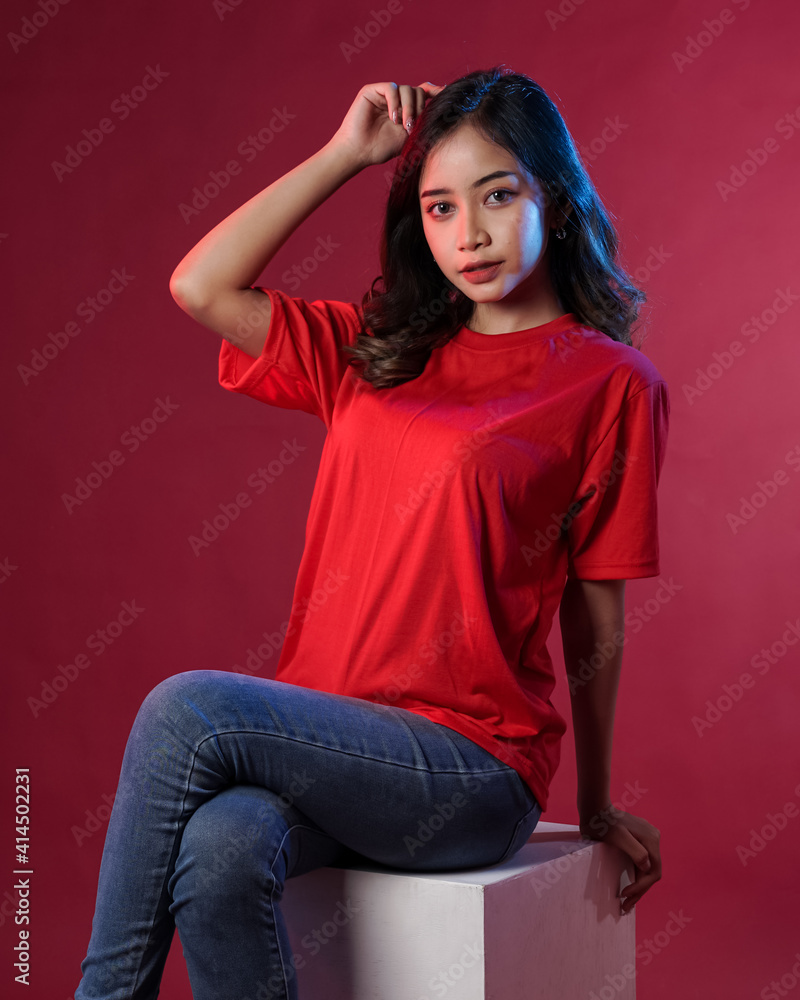 Young female model wearing blank T-shirt in studio background. Woman in ...