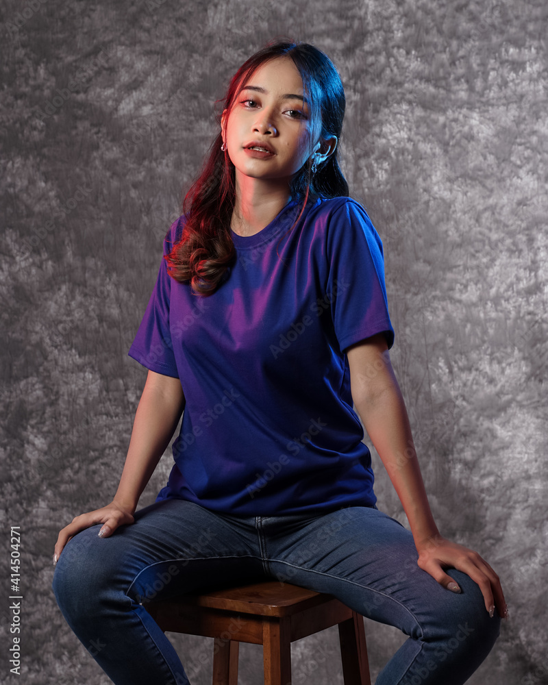 Young female model wearing blank T-shirt in studio background. Woman in ...
