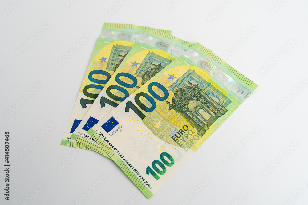Green new one hundred Euro banknotes on a white studio background. 100 ...