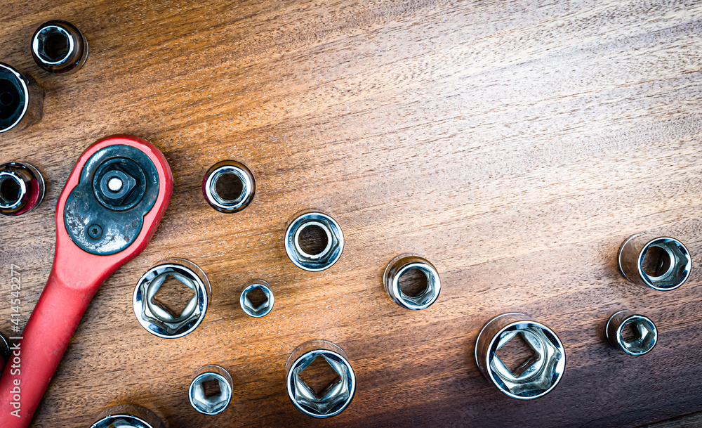 Set of hexagonal heads for ratchet key on brown wood texture background ...