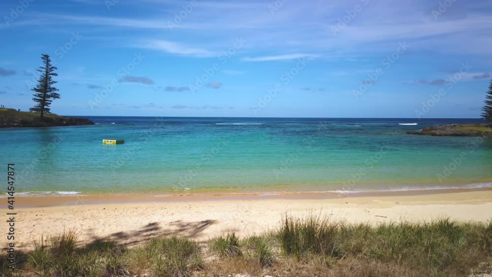 Left to right panning motion view of Emily Bay with sandy beach and ...