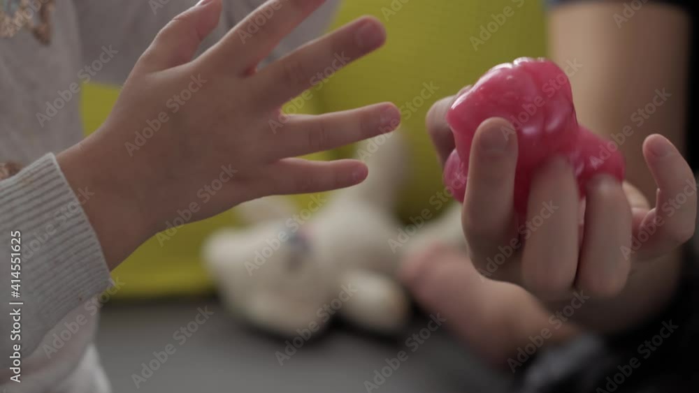 Hands with blue and red slime close up. Girl and boy preschool minor ...