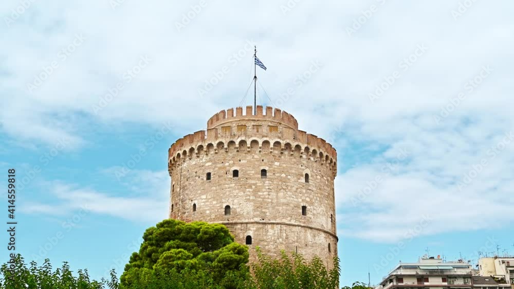 A White Tower view, a historically important building with a Greek flag ...