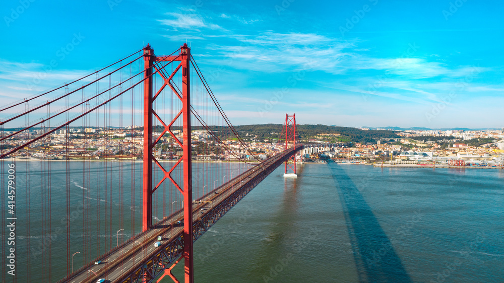 Aerial view or drone photo of the 25 De Abril Bridge. Red Lisbon bridge ...