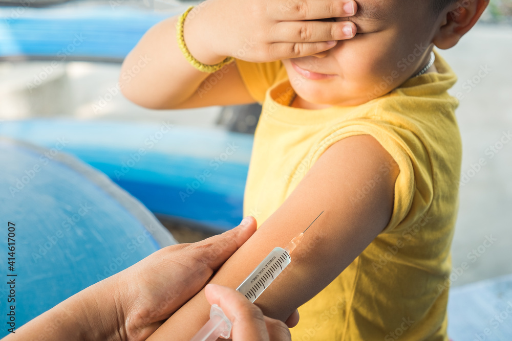 Scared little Asian boy receiving needle syringe vaccine dose from ...