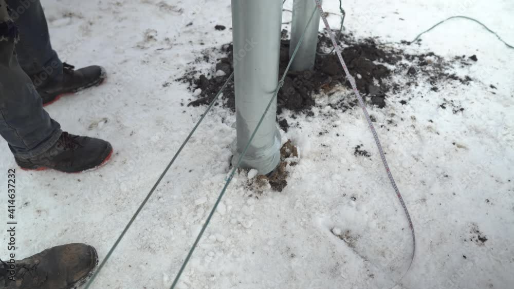 Video Stock Screwing screw piles into the ground at a construction site ...