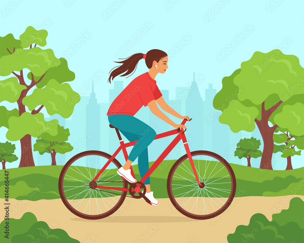 Young woman rides a bicycle in sportswear in city park. Concept of ...