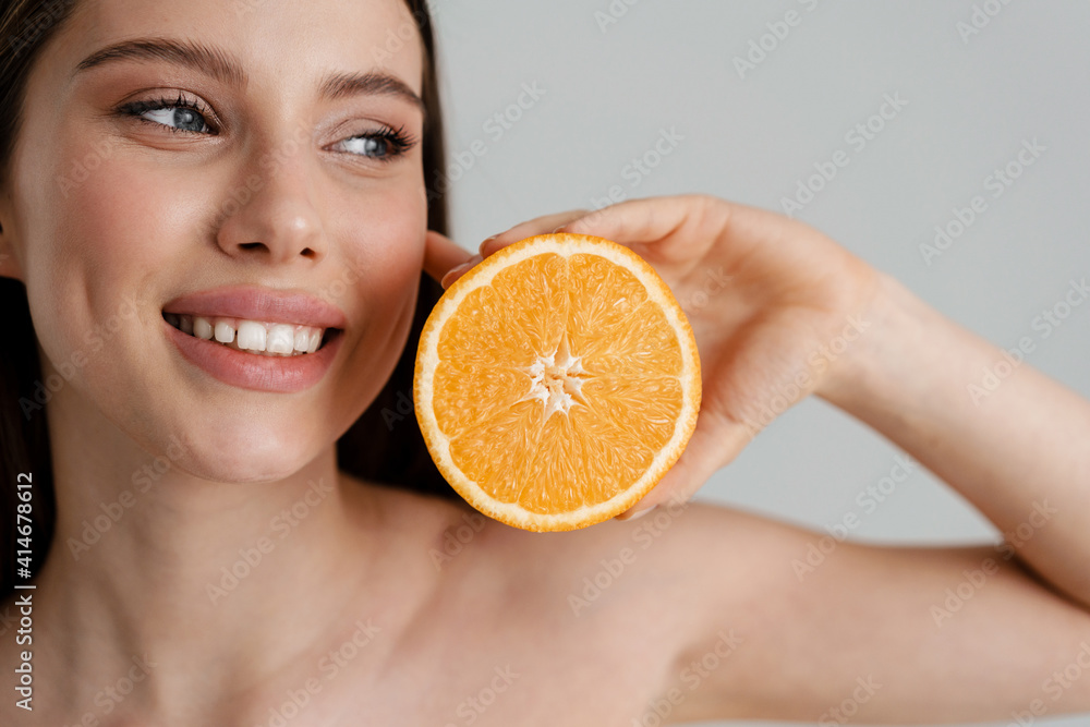 Happy shirtless girl smiling while posing with orange Stock Photo ...