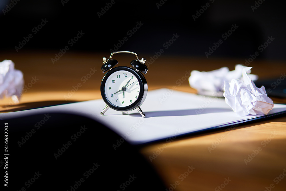 Modern workplace, wooden office desk in hardlight, sunligt with clock ...