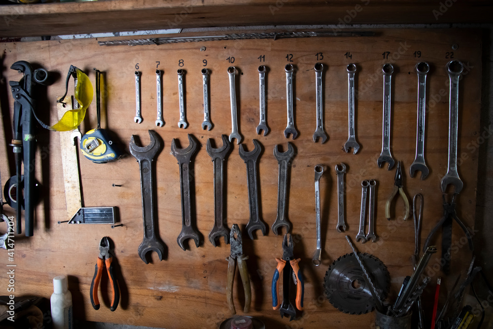 Wood wall with tools.Old tools hanging on the wall in the garage ...