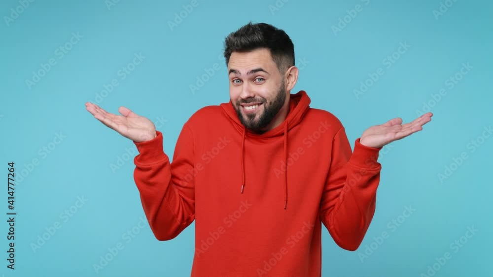 Confused puzzled bearded young man 20s years old in casual red ...