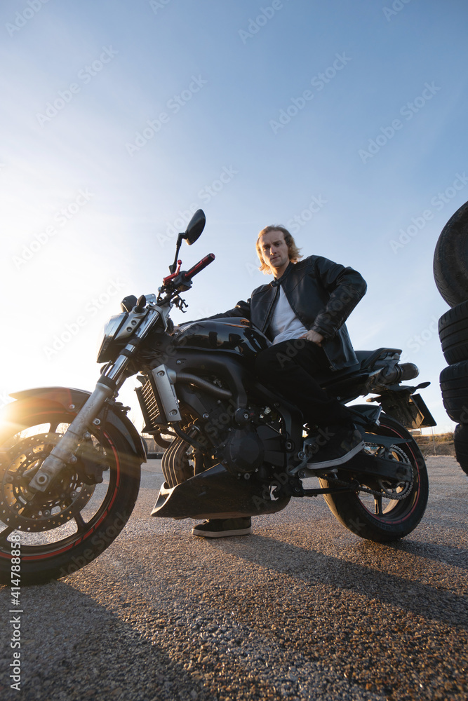white caucasian man blond long hair biker riding a motorcycle with ...