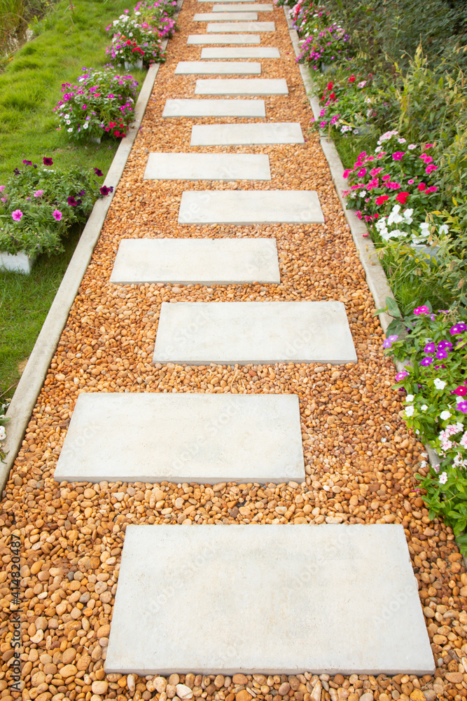 Selective focus shot of white stone path with yellow and brown gravel ...