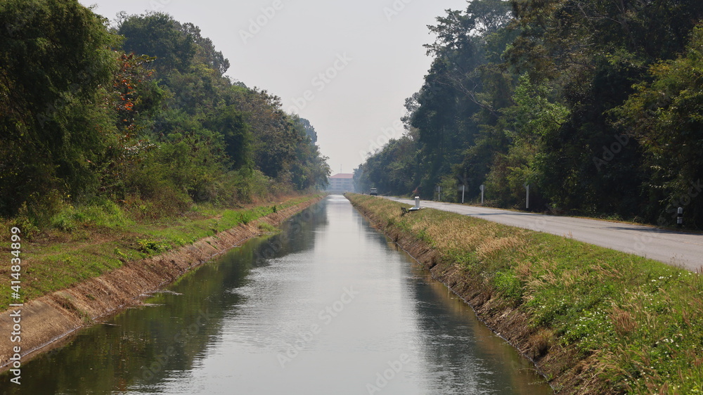 Irrigation canals and roads. Irrigation channels in concrete walls ...