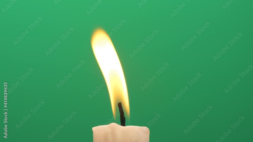 Closeup candle fire flame burning on chroma key green screen background ...