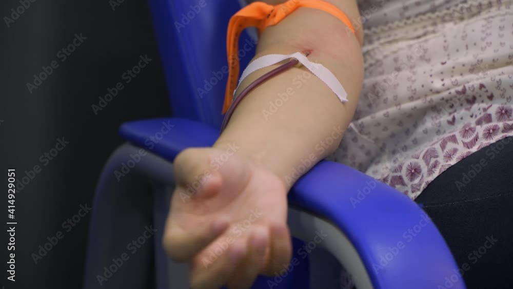 Front close-up, still shot of a woman arm while opening and closing her ...