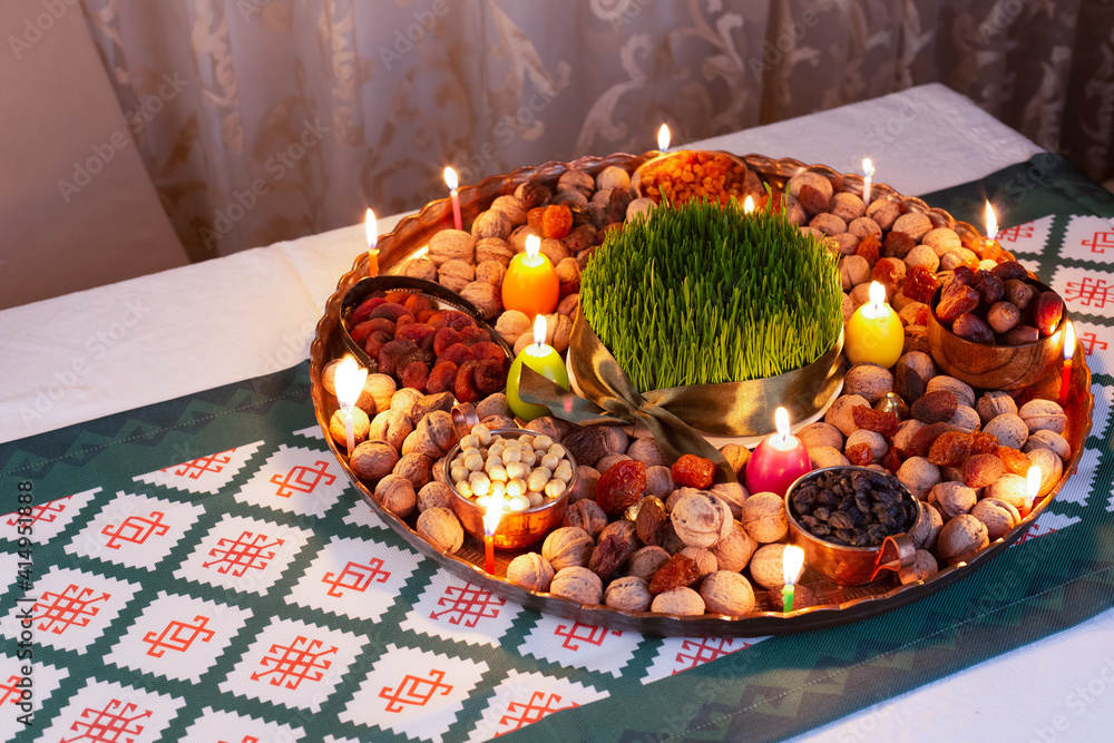 Novruz traditional tray with green wheat grass semeni or sabzi, sweets ...