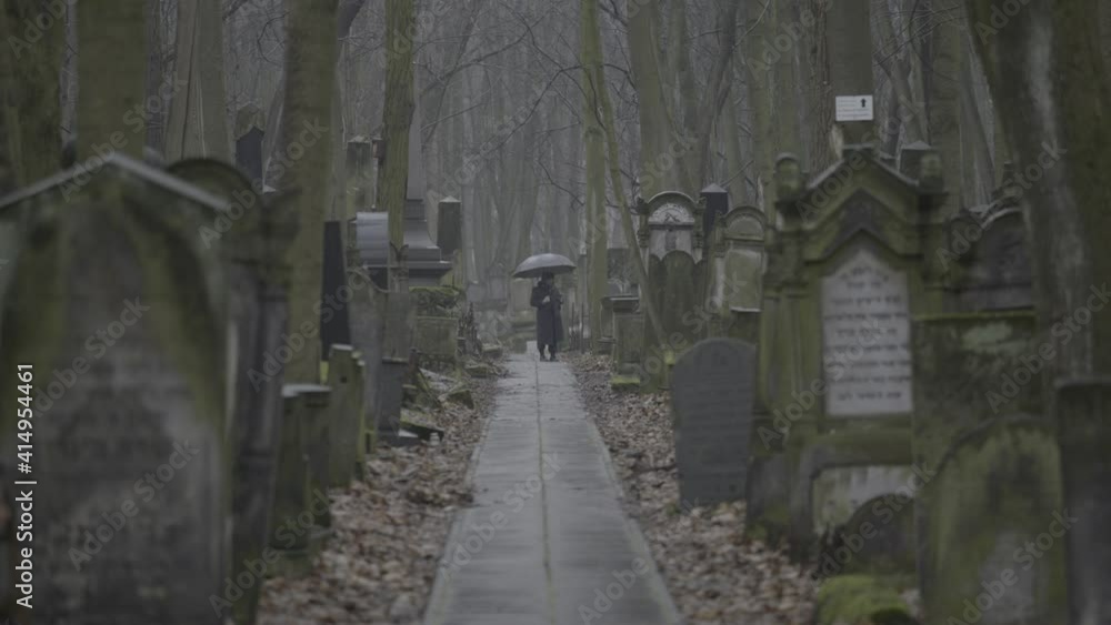 A telephoto of a huge Jewish cemetery, where an Orthodox Jew is ...