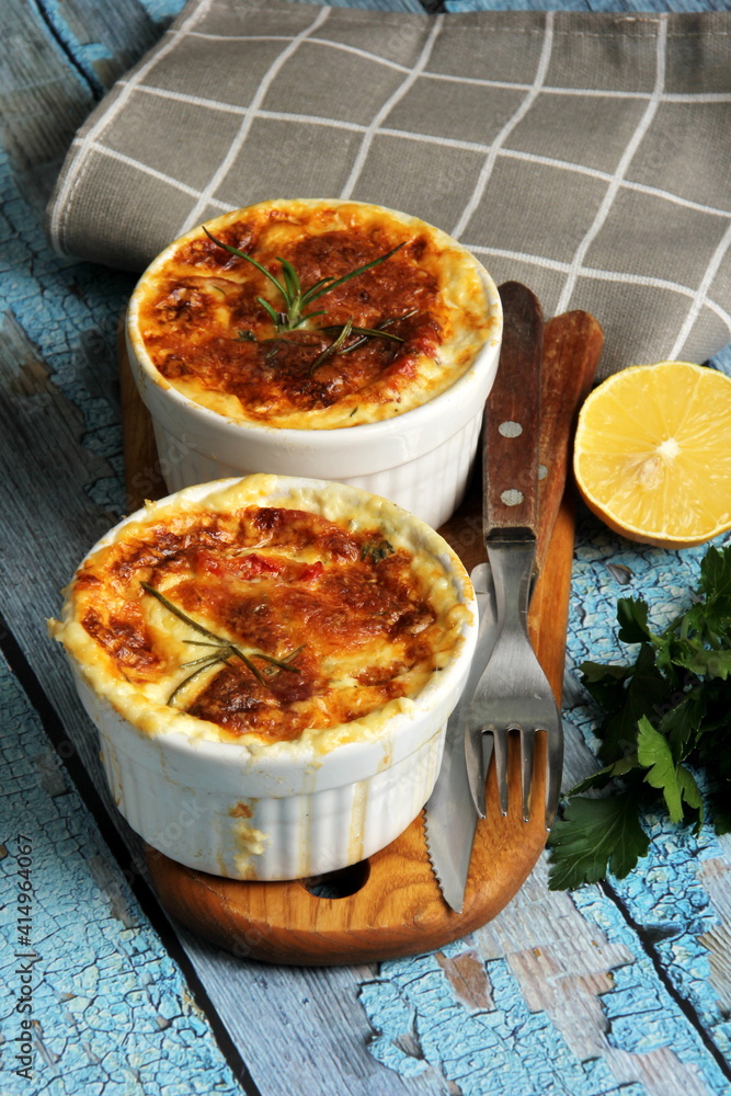 Cod casserole with cheese, sour cream and tomatoes. White fish ...