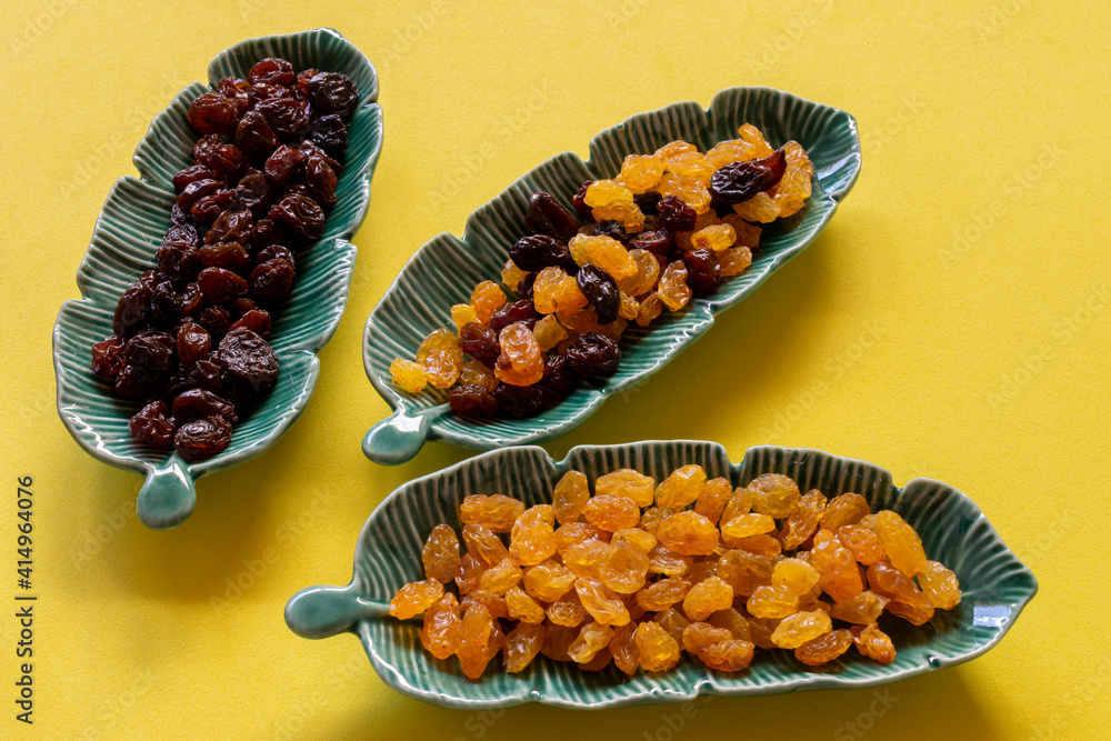 leaf-shaped ceramic pots with dark, light and mustured raisins. Stock ...