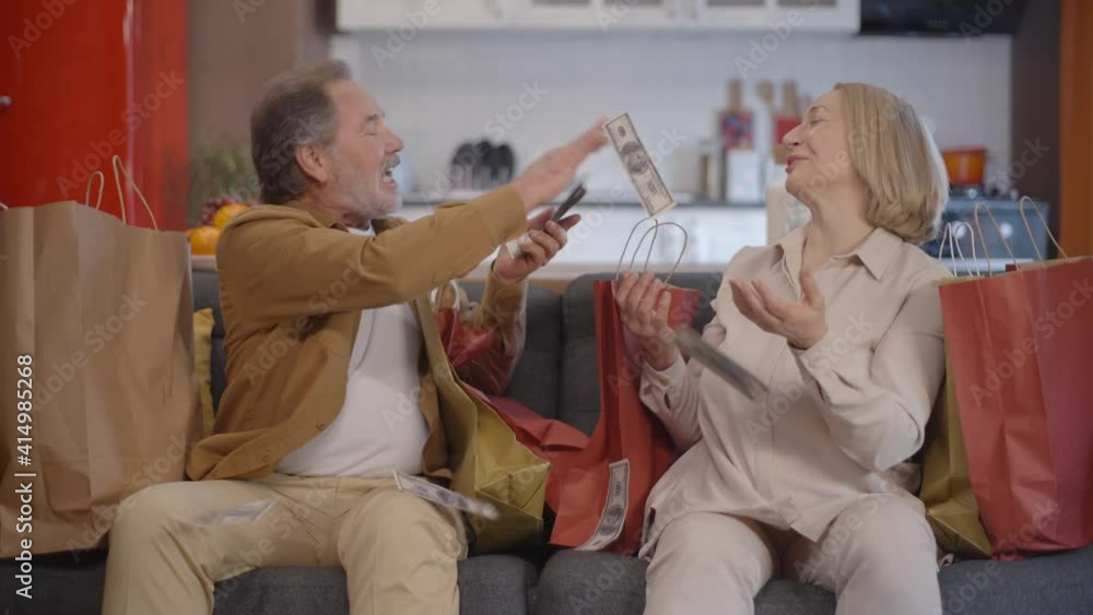 Happy old man scatters money on his wife.Crazy old couple just coming ...
