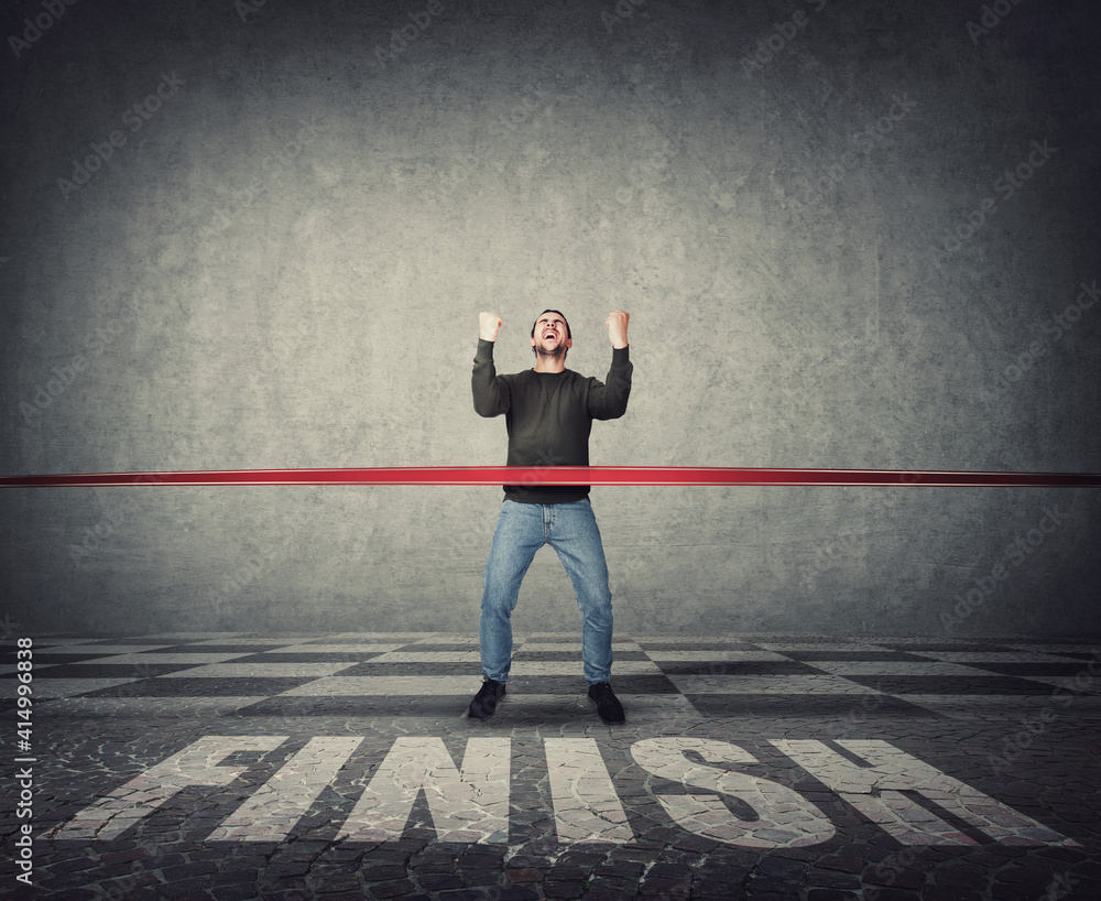 Passionate man winner, keeps fists tight, shouting and screaming as ...