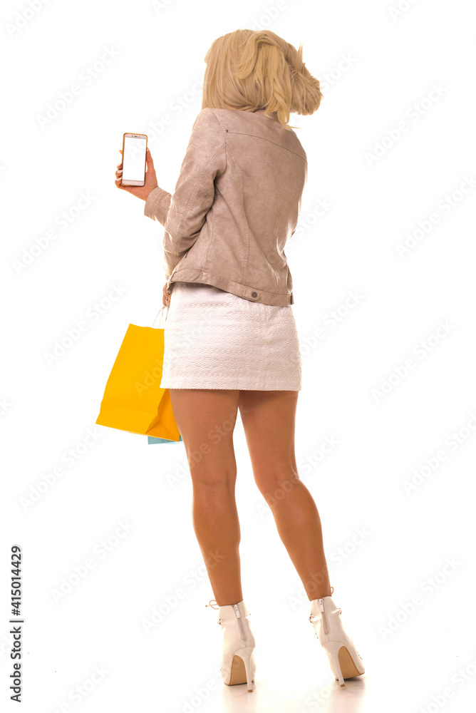 Blonde girl stands with her back to the camera. Stock Photo | Adobe Stock