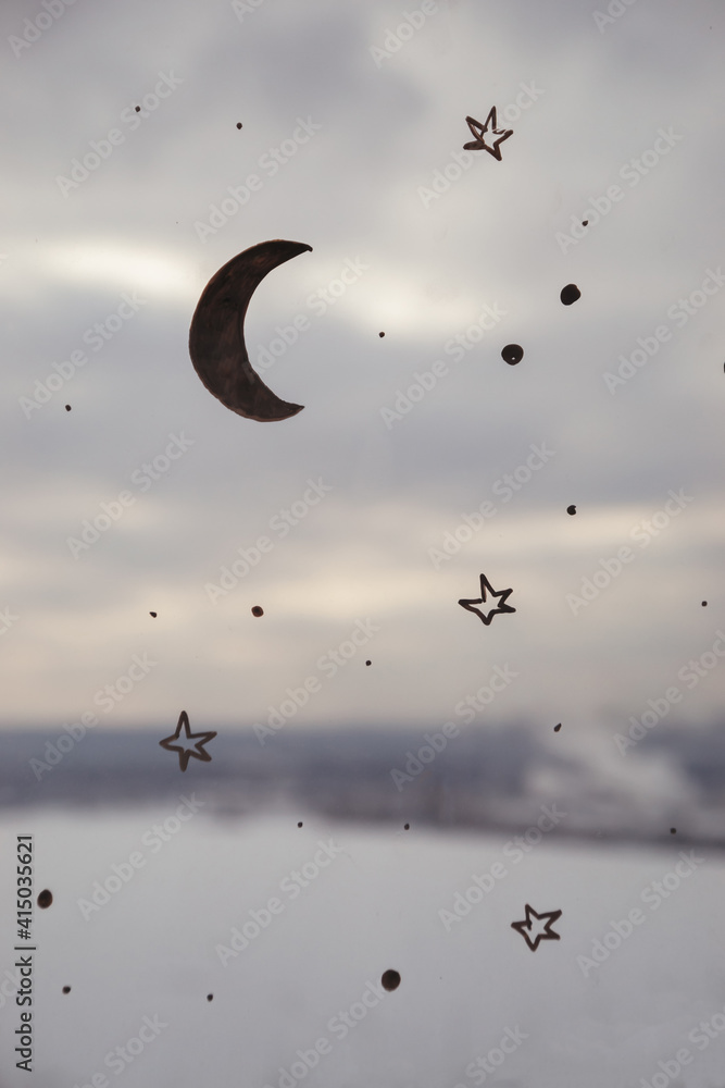 Close up picture of drawing moon and stars on the window, as ...