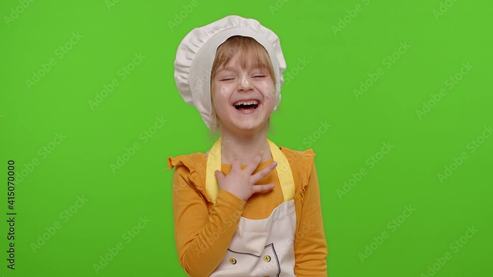 Child girl dressed cook chef baker in apron and hat laughing out loud ...