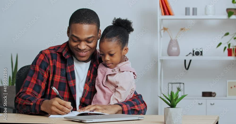 Afro american single father checking homework helping cute african ...