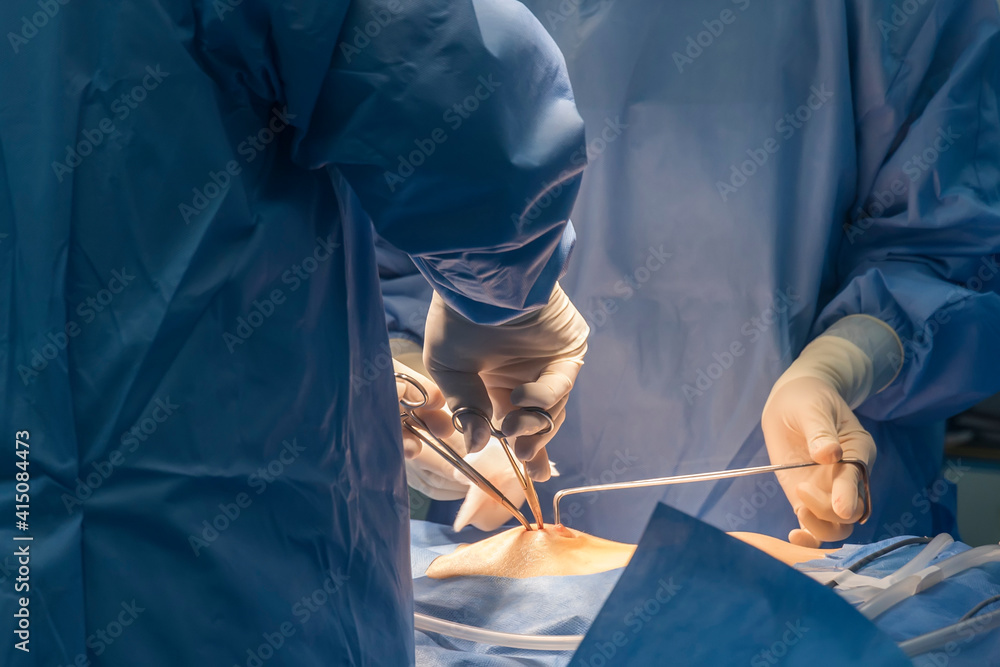 lose up photo of Surgeon in blue surgical gown suit working inside ...