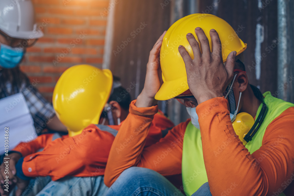 Engineers sitting sad at the job site is unemployment and the economic ...