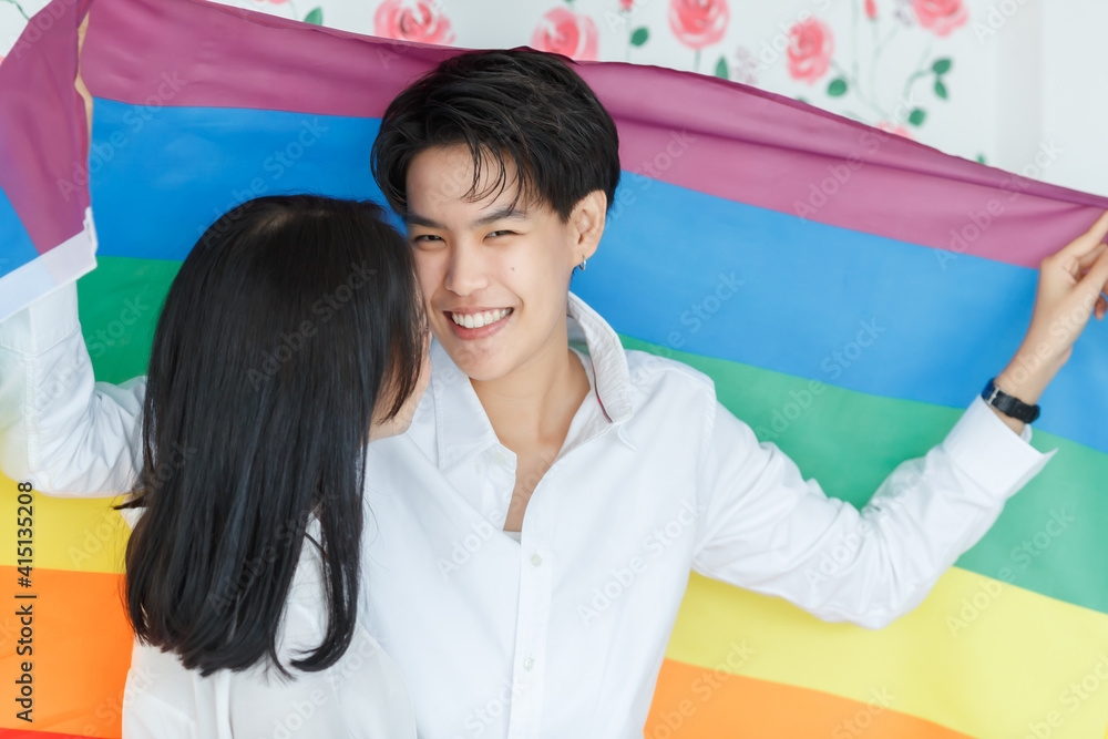 LGBTQ couple lovers, a handsome girl as a man or butch femme covered ...