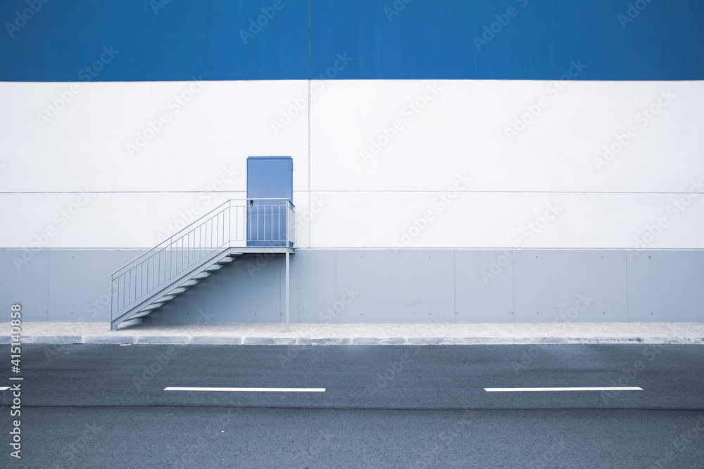 Facade of a modern building with grey and blue horizontal lines and ...