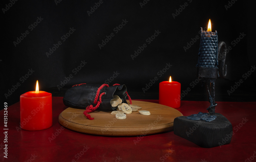 The Runa Berkana. A composition of burning candles, inverted runes, and ...