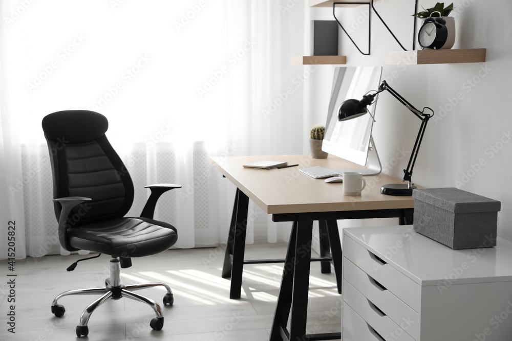 Comfortable office chair near table with modern computer Stock Photo ...