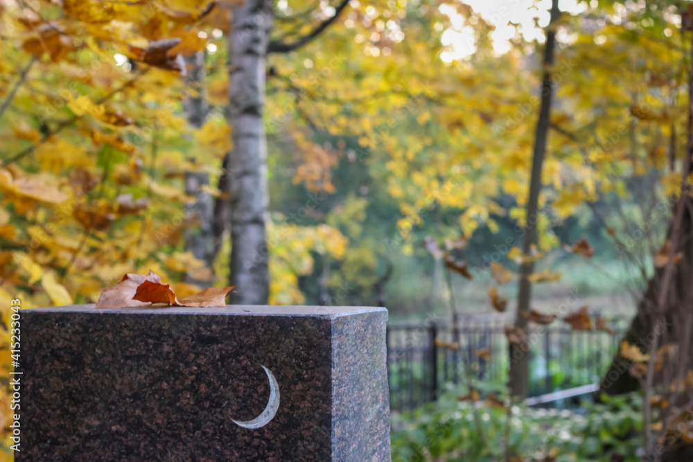White crescent moon symbol on the grave rectangular granite slab ...