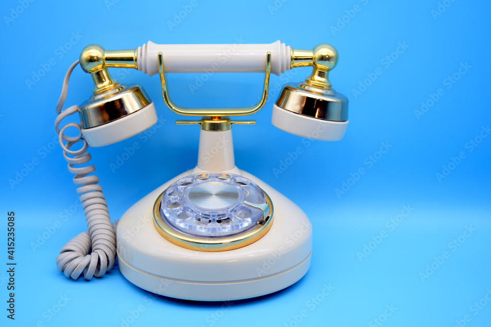 Retro antique vintage rotary phone isolated on blue background. Offset ...
