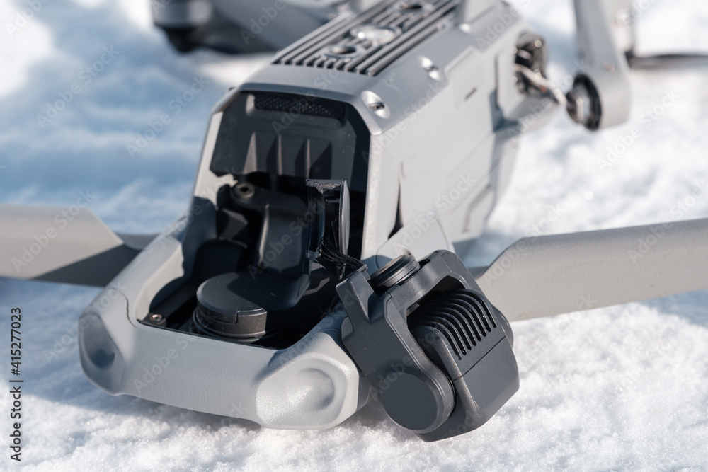 Broken gimbal camera and drone motor arm after crash on snow outdoor ...