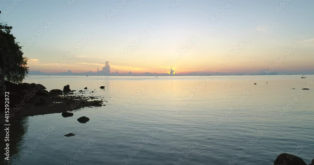 Sunrise Thailand aerial silhouette: woman rise up hands, stays on rocky ...
