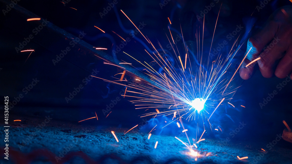 Welding of steel, sparking, not wearing gloves, light colored like ...