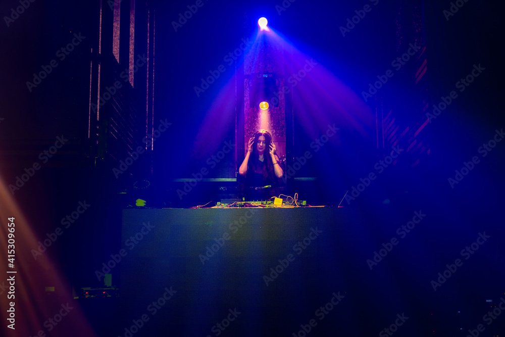 DJ on stage in disco night club mixing techno music beat . Nightlife ...