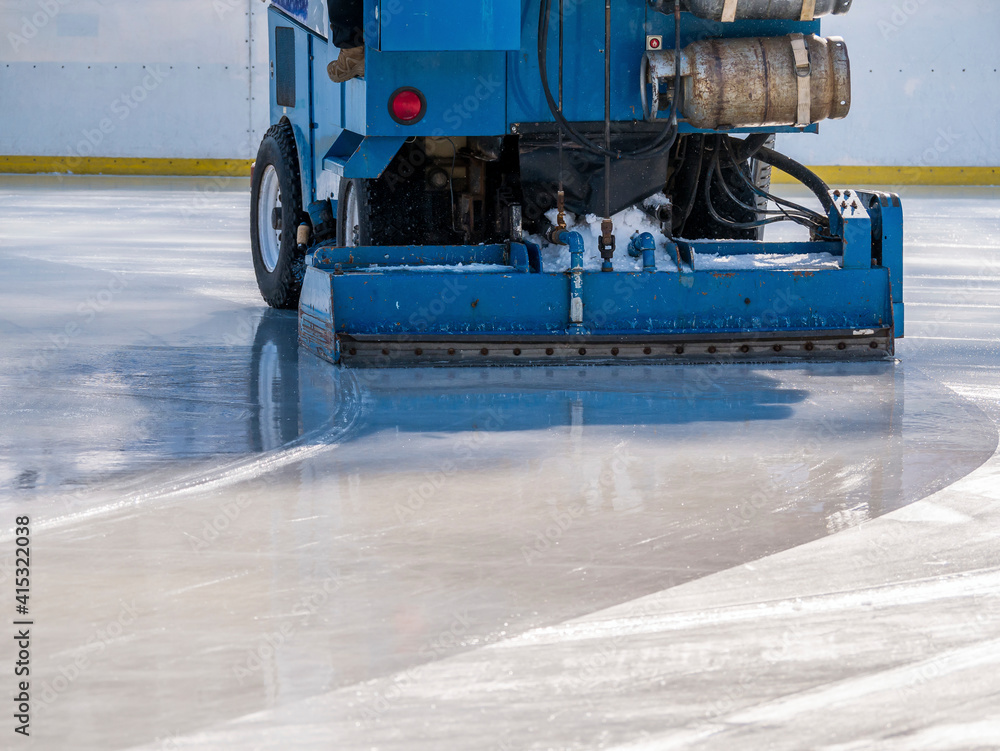 Ice resurfacer smoothing and polishing the surface of the ice rink ...