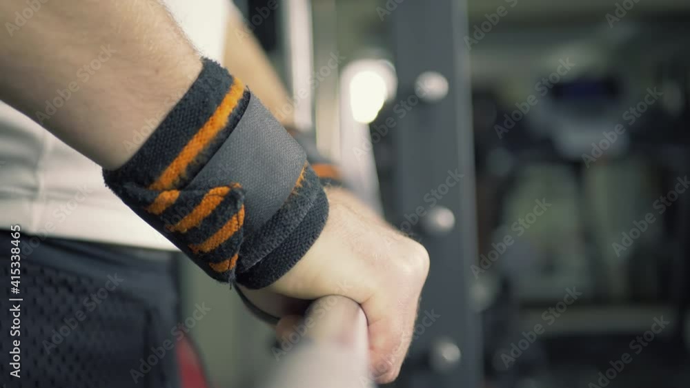 Powerlifter performs strength exercises of the shoulders and back ...