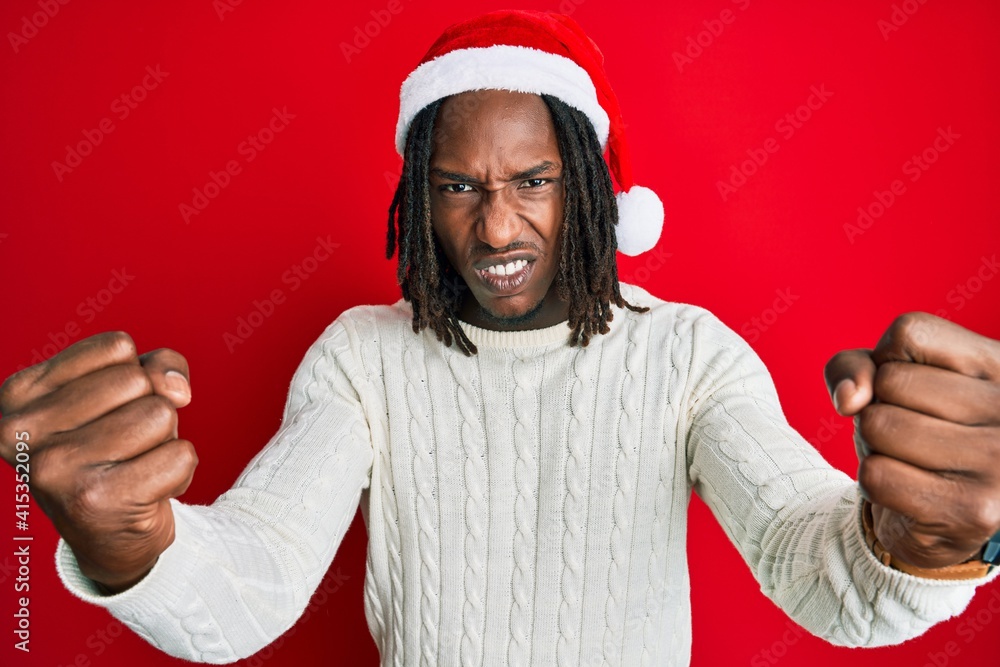 African american man with braids wearing christmas hat angry and mad ...
