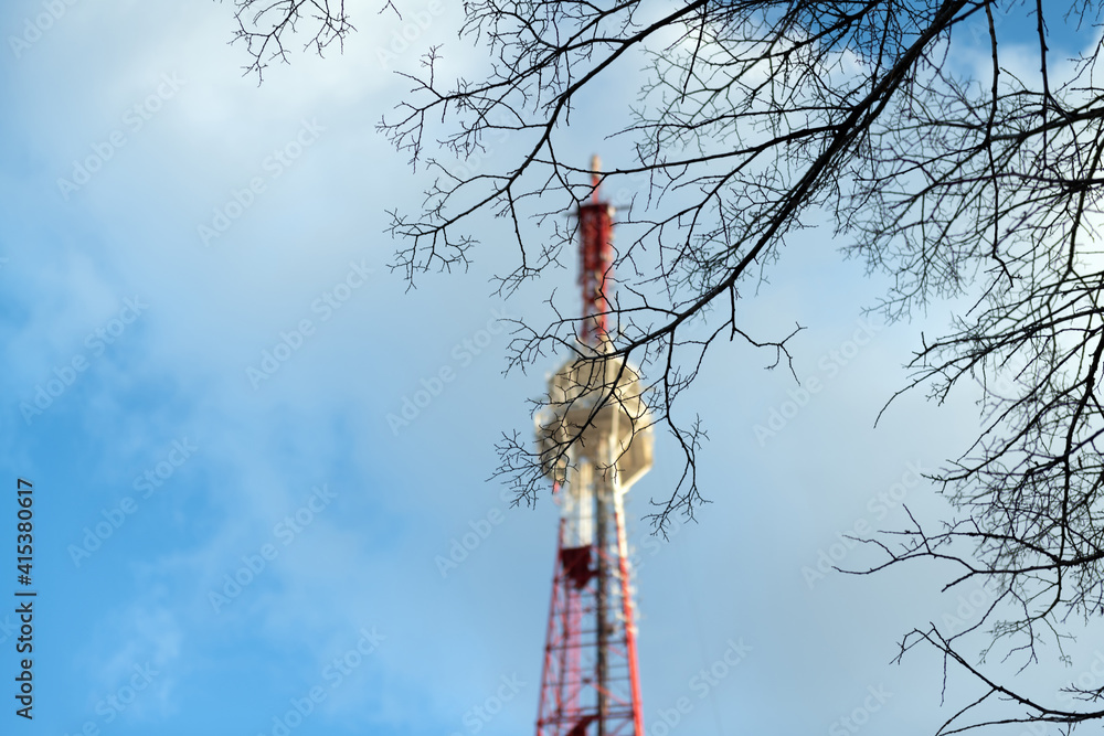 Blurred background. Telecommunication tower in blurry focus against a ...