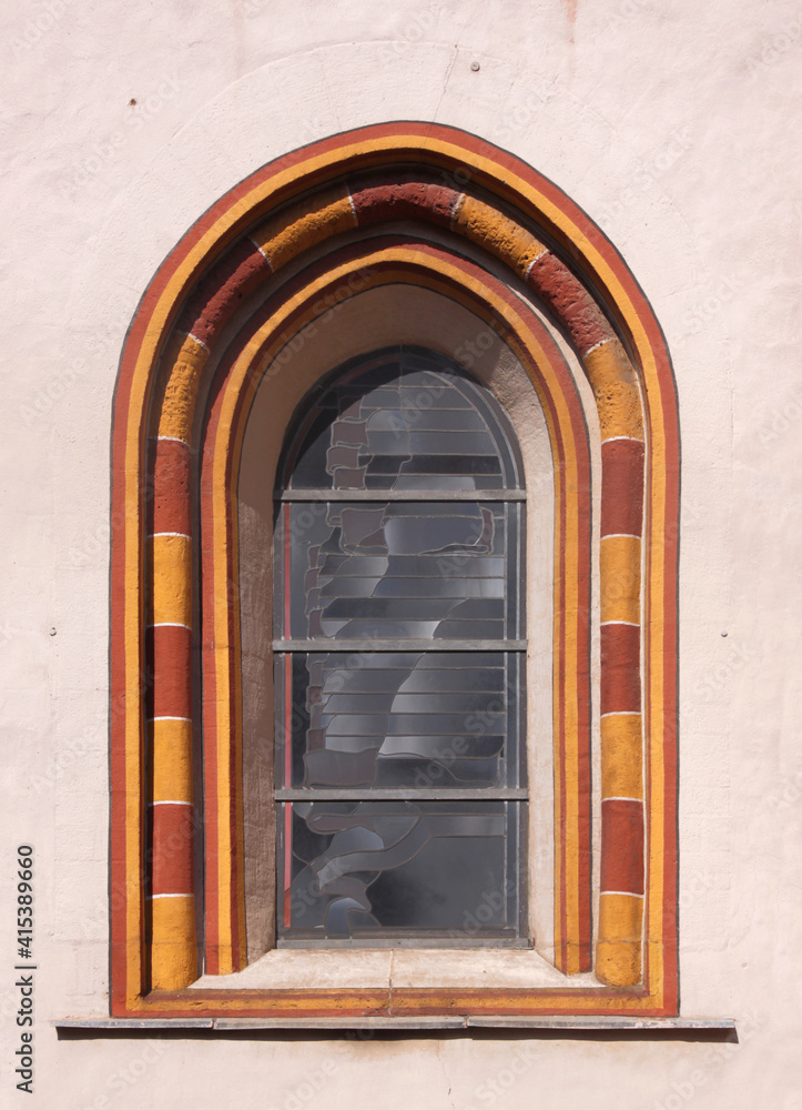 Romanesque round arch with painted frame and contemporary stained glass ...