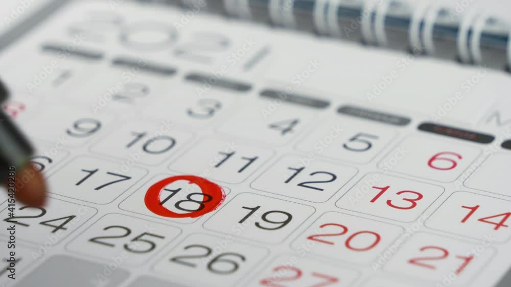 Calendar mark. Hand marking day on calendar with a red marker. Calendar ...