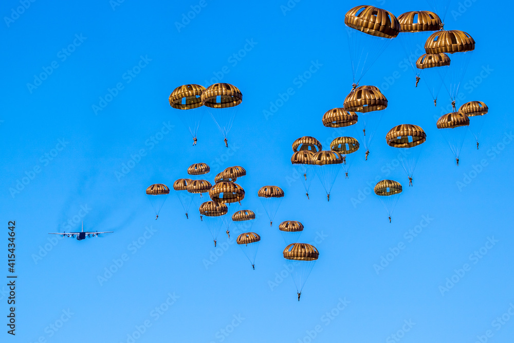 Military parachutist paratroopers parachute jumping out of a air force ...