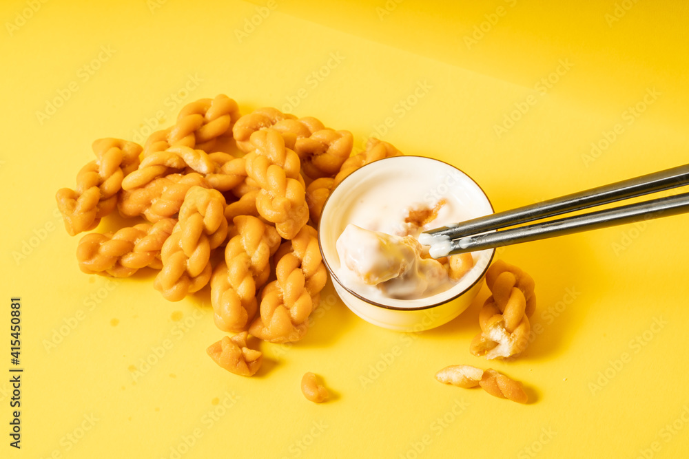 Traditional Chinese snack honey mahua on a solid color background Stock ...